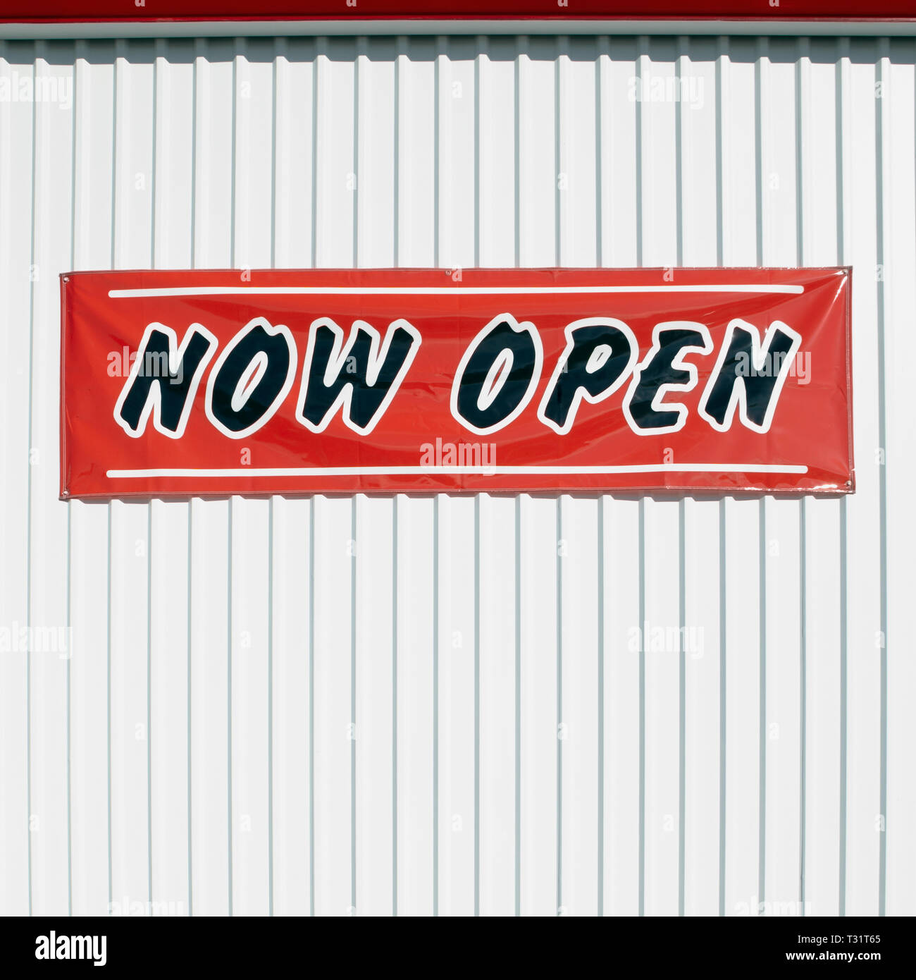 Now Open sign hanging on wall Stock Photo - Alamy