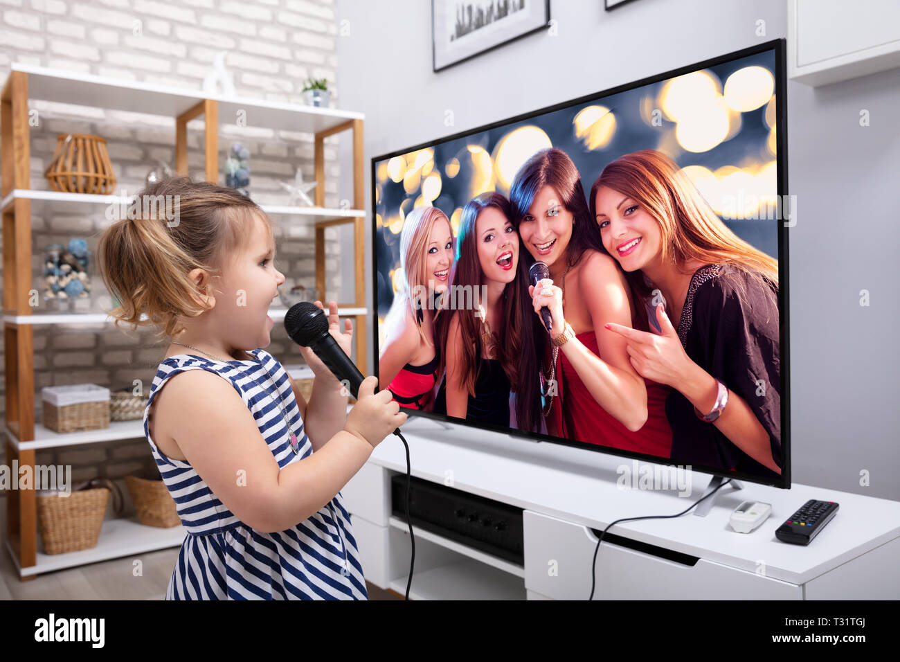 Close-up Of A Happy Girl Singing Song With Microphone In Front Of ...