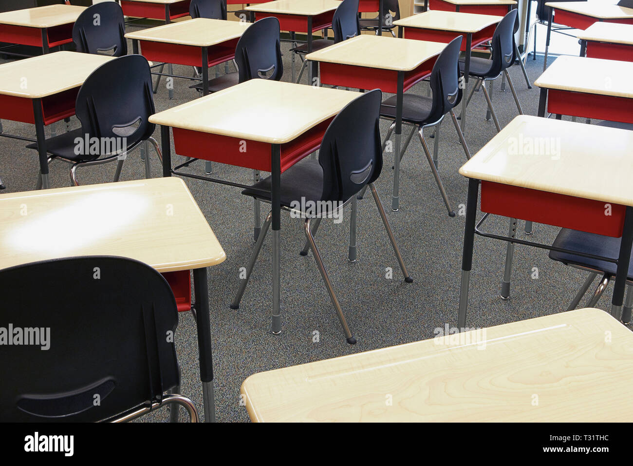 Desks and chairs in empty classroom Stock Photo - Alamy