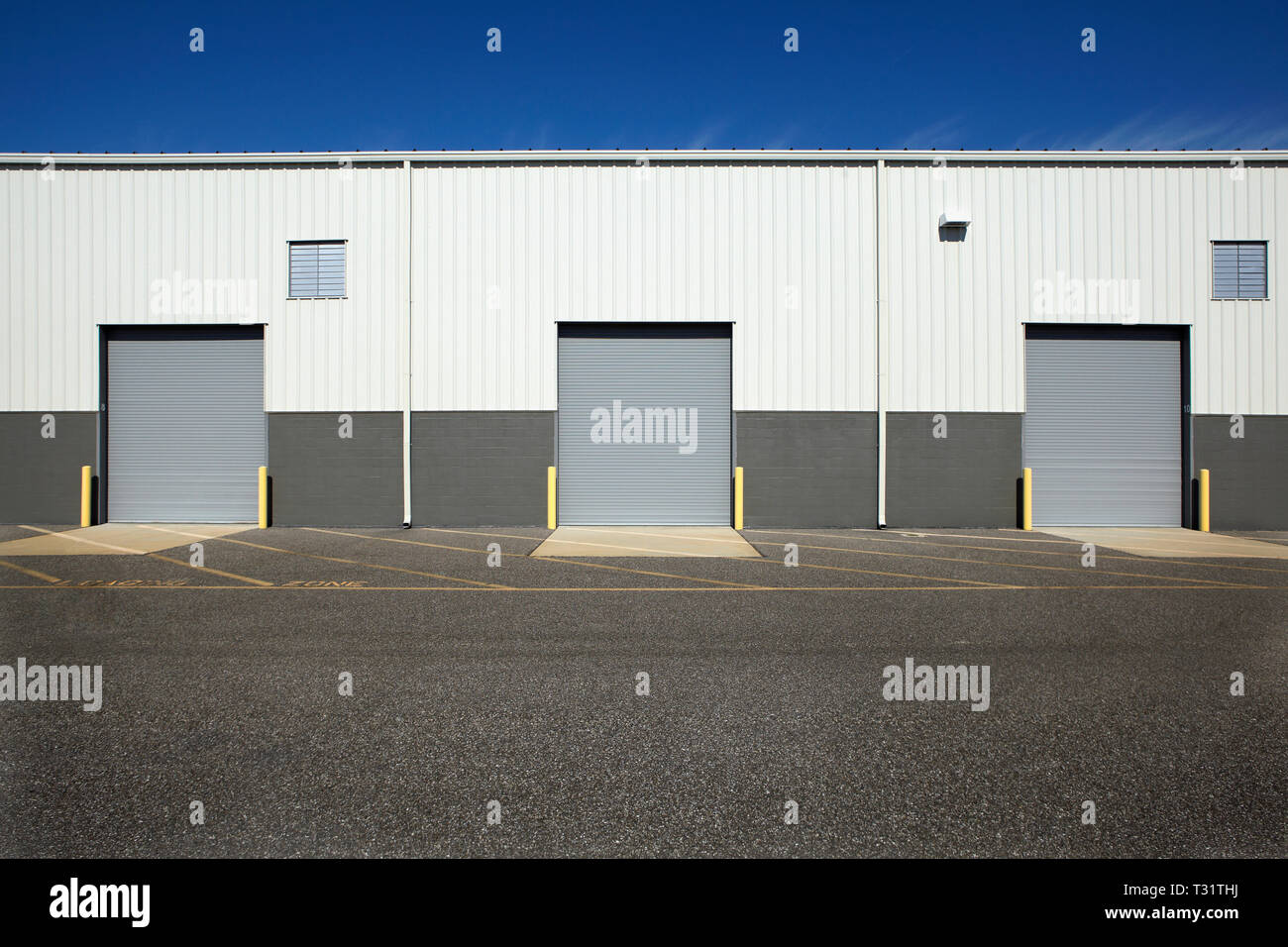 Closed doors at warehouse loading dock Stock Photo - Alamy