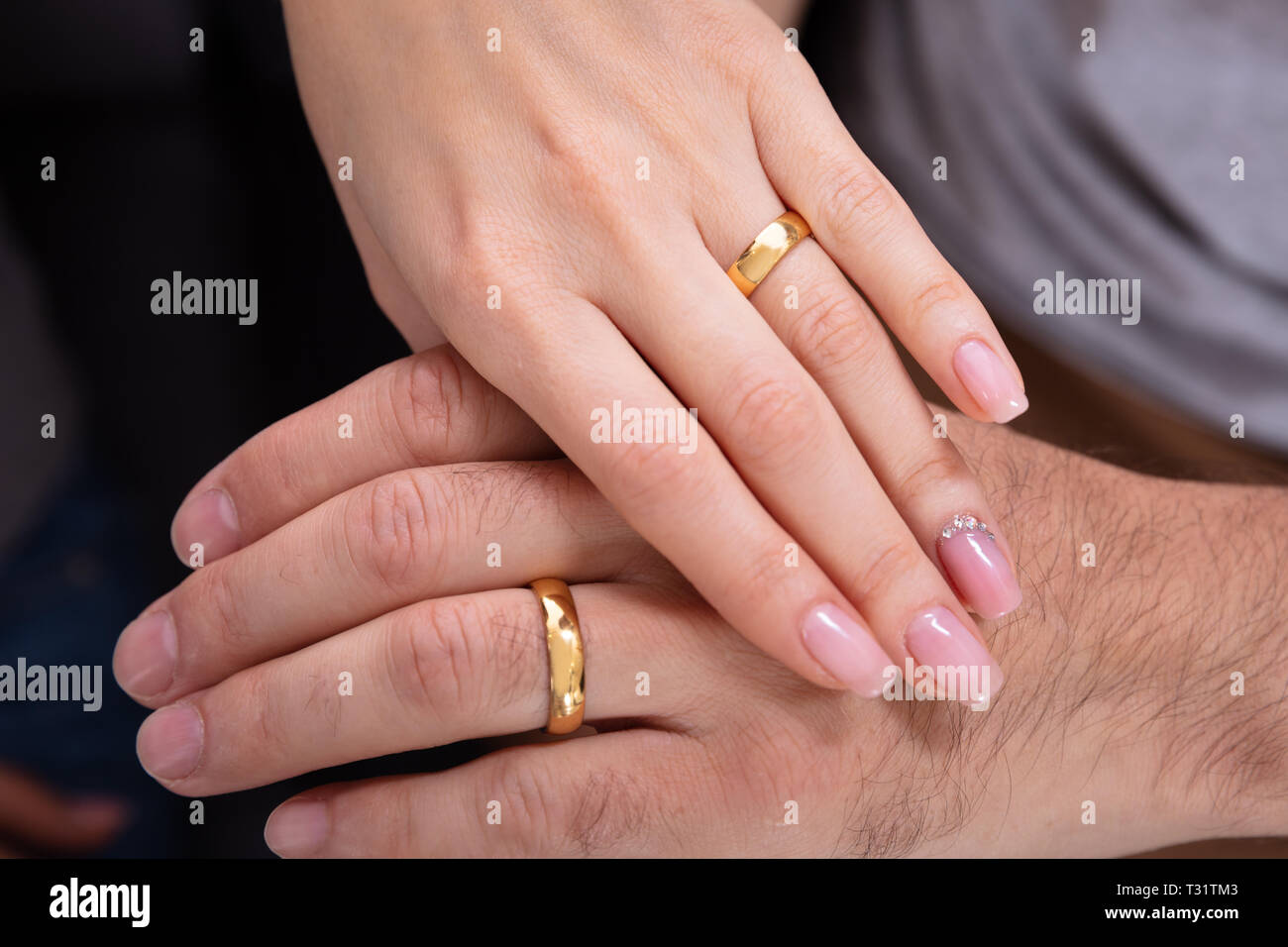 High Angle View Of A Couple's Hand Showing Their Wedding Rings Stock ...