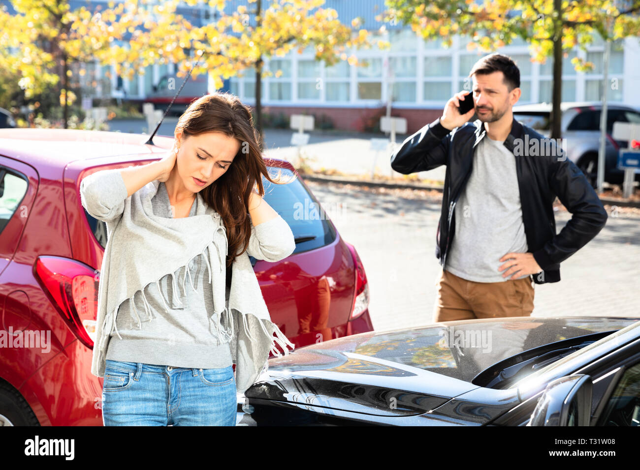 Man Calling For Assistance In Front Of Sad Woman Looking Damaged Car On ...