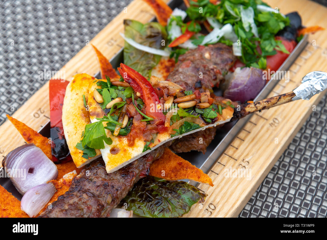 Adana-kebab with vegetables and pita bread - a traditional Turkish dish ...