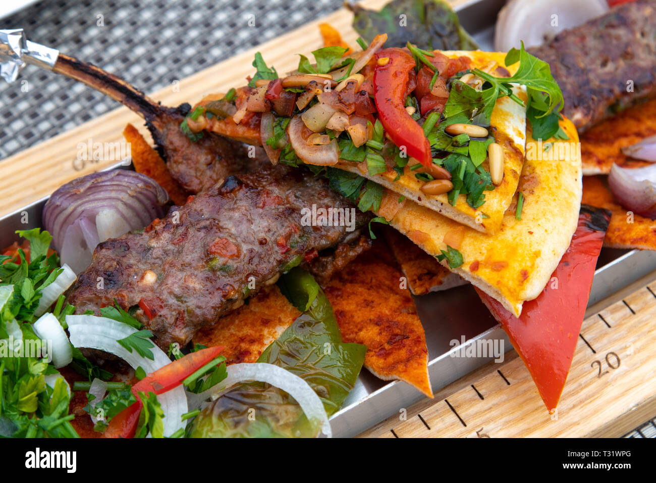 Adana-kebab with vegetables and pita bread - a traditional Turkish dish ...