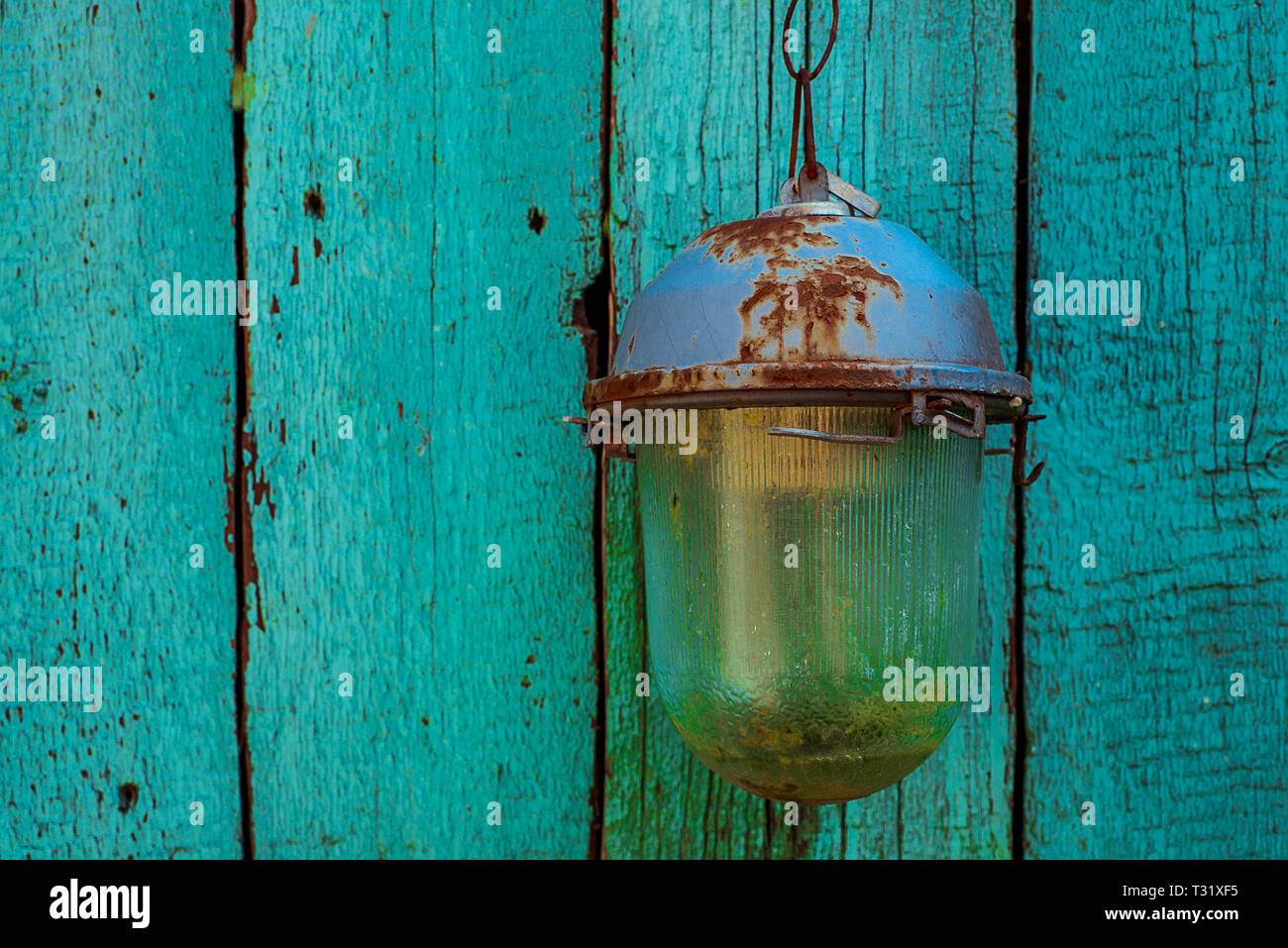 Old rusty lamp on old green wood wall. Horizontal grunge texture Stock ...