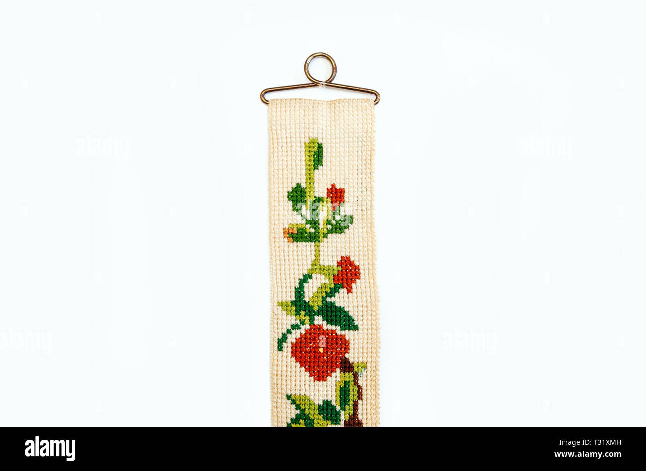 Old vintage dutch embroidery cross with red and green threads on the ...