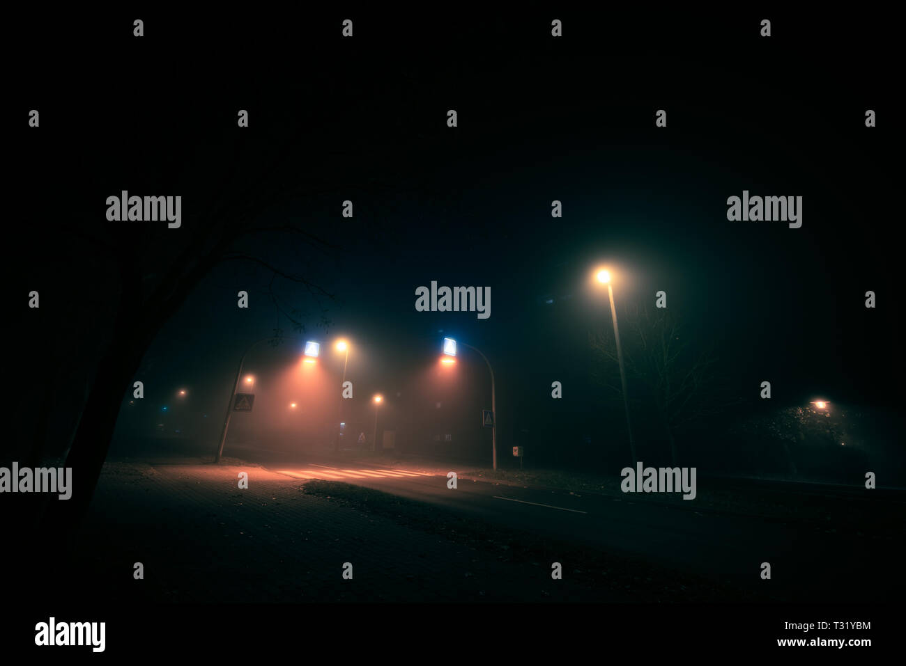 Fog at the crossroads in the night city Stock Photo - Alamy