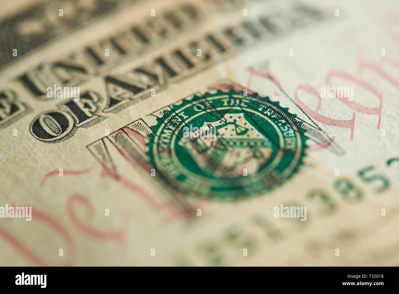 Green stamp on dollar banknote close up view Stock Photo - Alamy