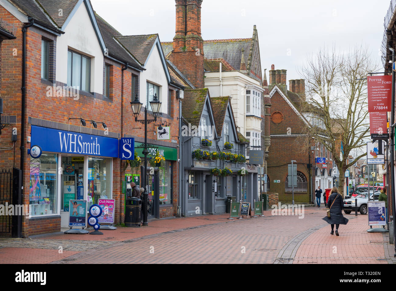 Solitary woman walks past The Generals Arms pub, High Street, Chesham ...
