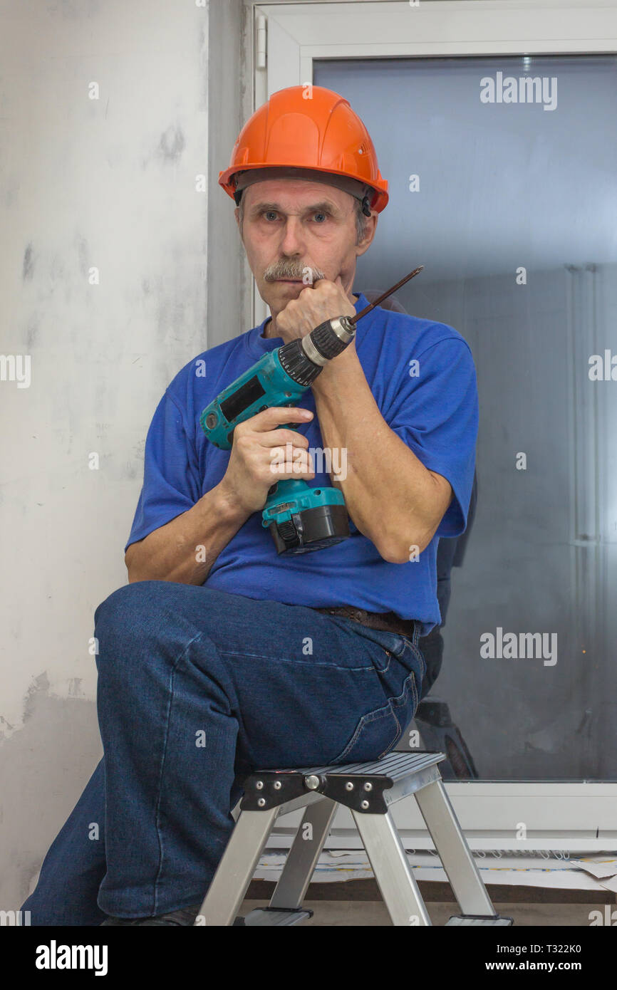 Man sitting on stepladder hi-res stock photography and images - Alamy