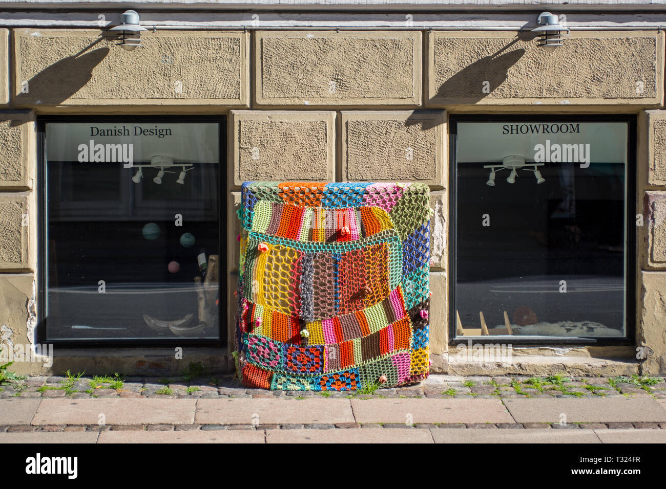 A colourful patchwork blanket adorns a wall at a Danish Design showroom ...