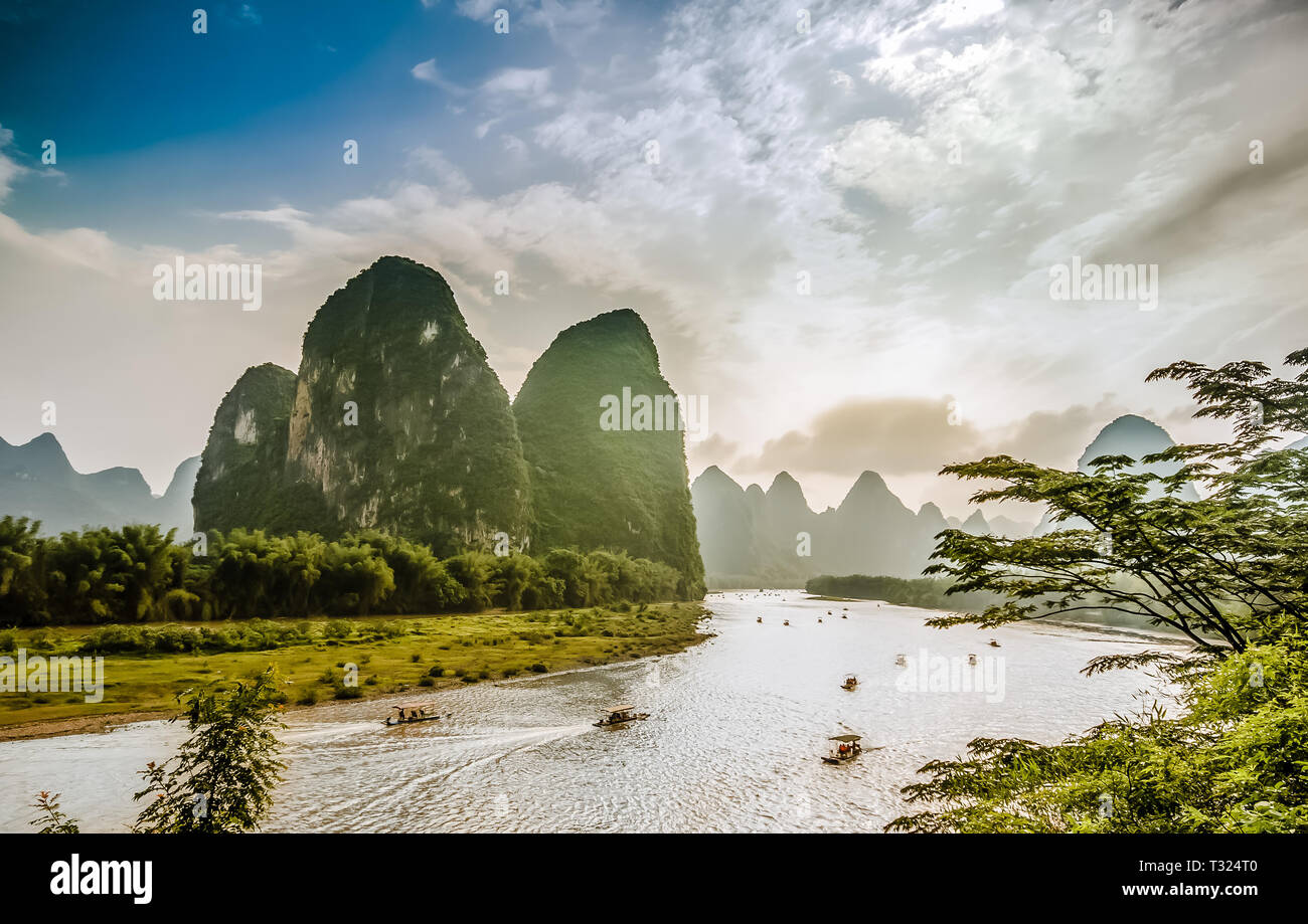 Boats on Li River in Yangshuo China surrounded by Karst Mountains Stock ...