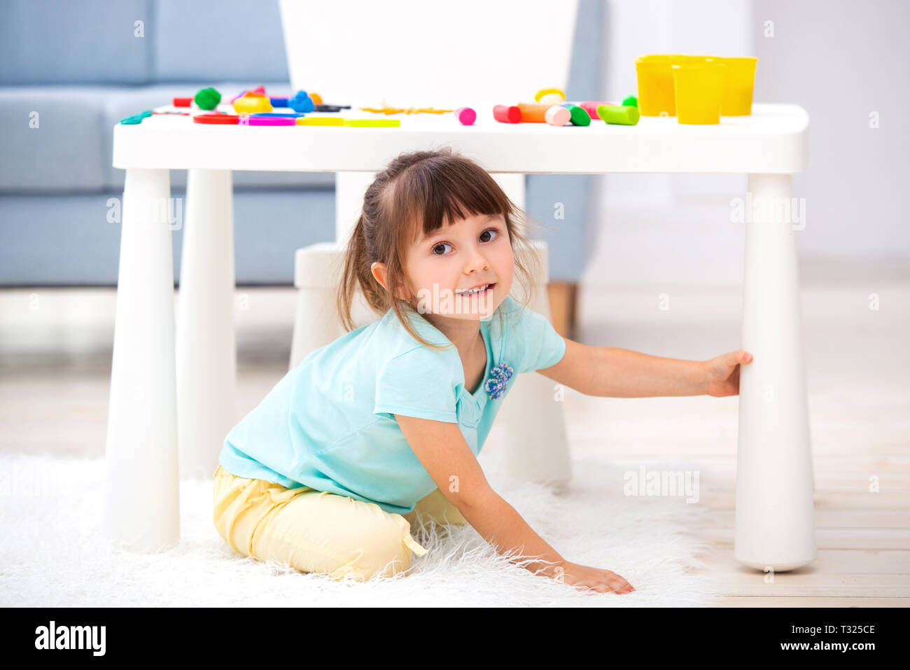 Baby looking under table hi-res stock photography and images - Alamy