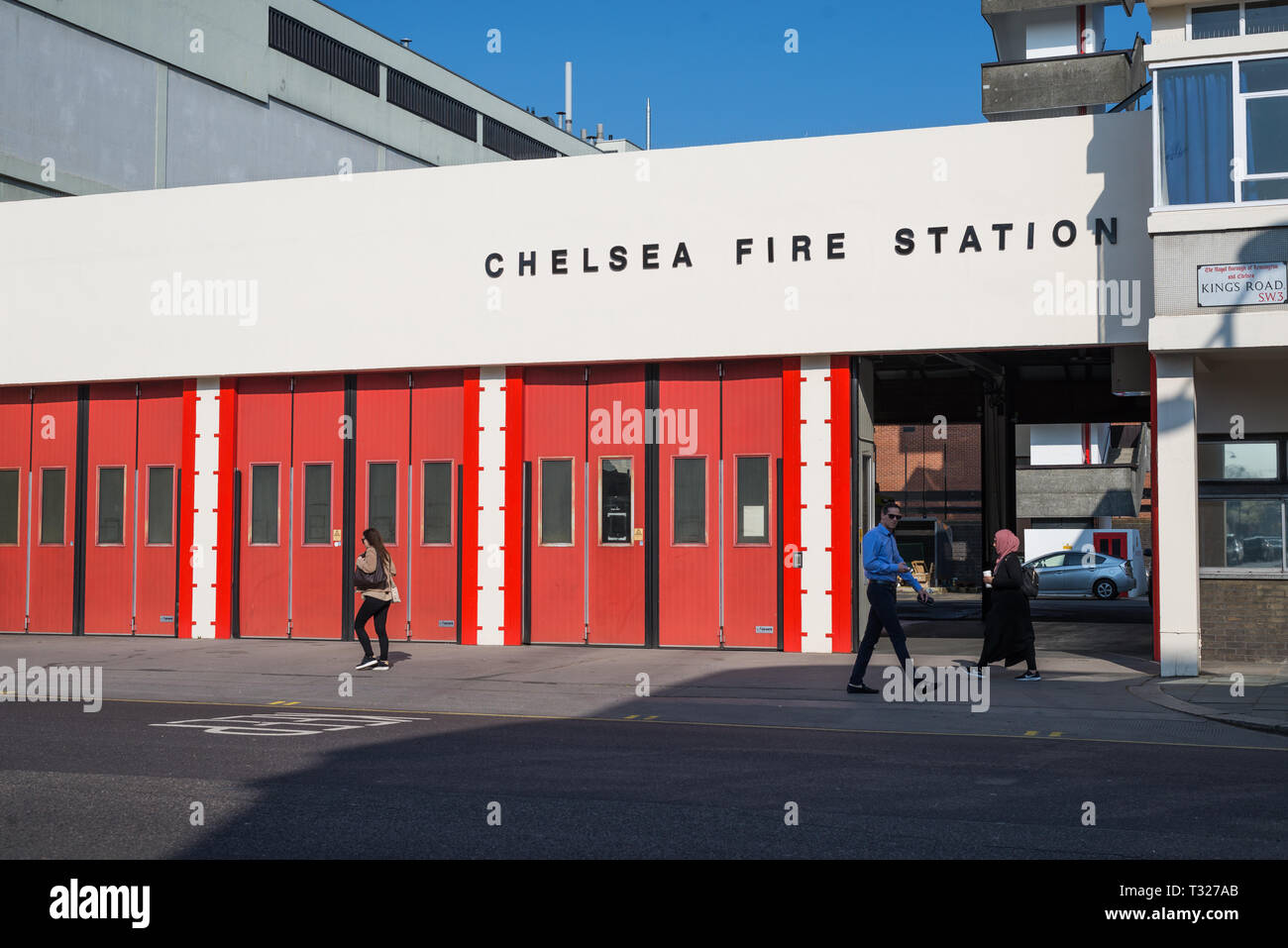 A man and two women walking past Chelsea fire station in King's Road ...