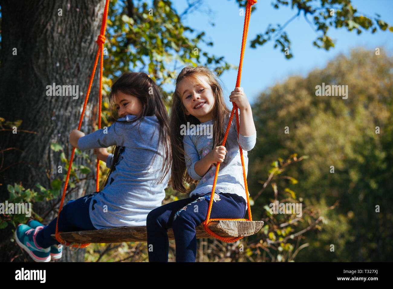 Happy girls enjoy good weather and sunlight. Beautiful kids laying and ...