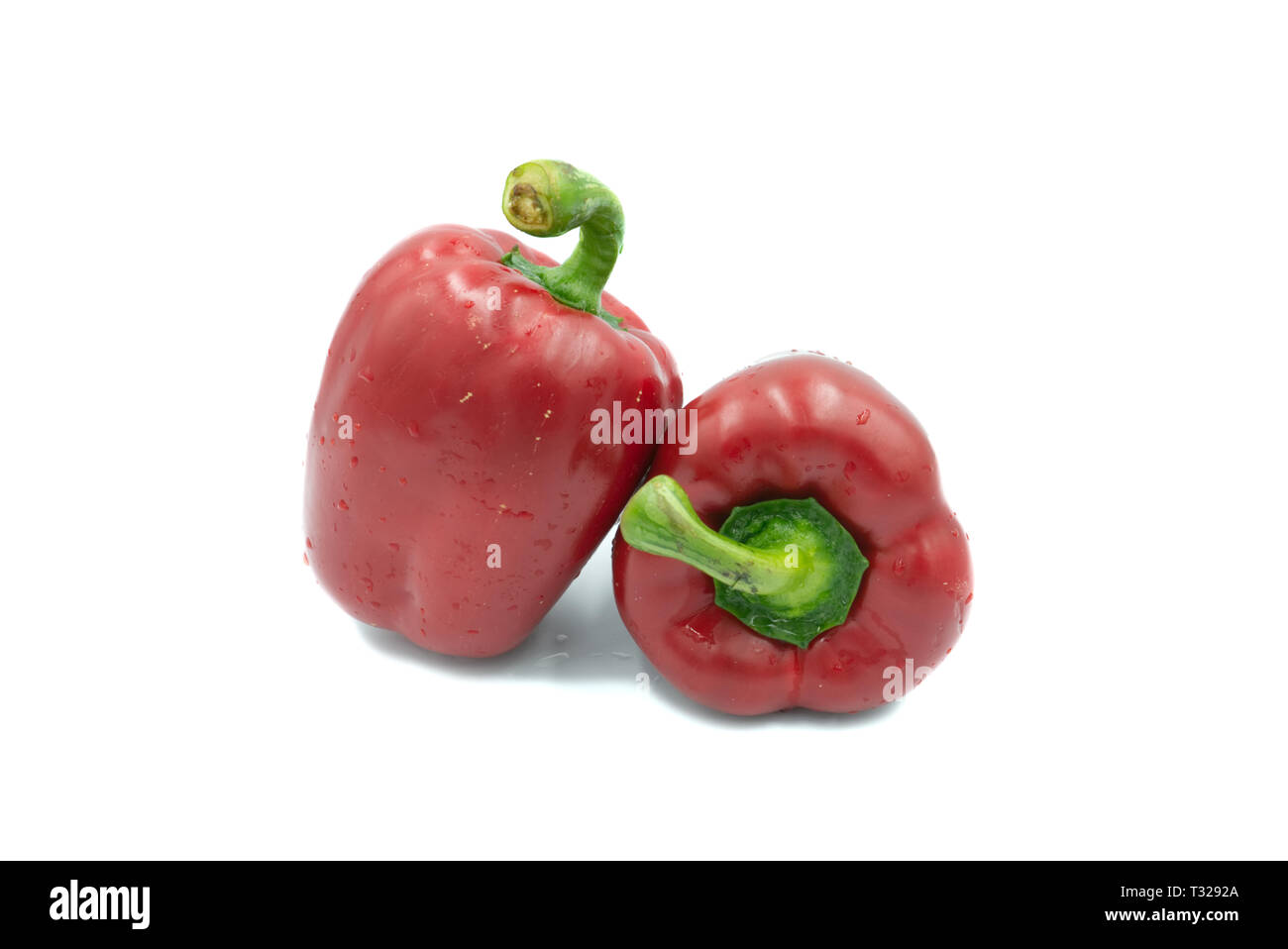 Two washed red ripe bell peppers on white background Stock Photo - Alamy