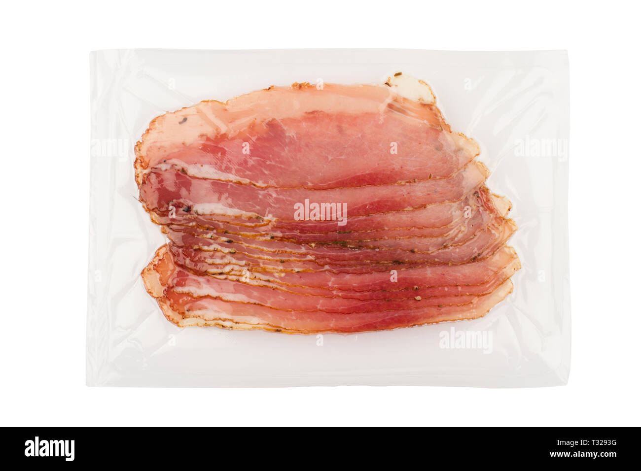 top view of slices of smoked pork loin ham in transparent plastic ...