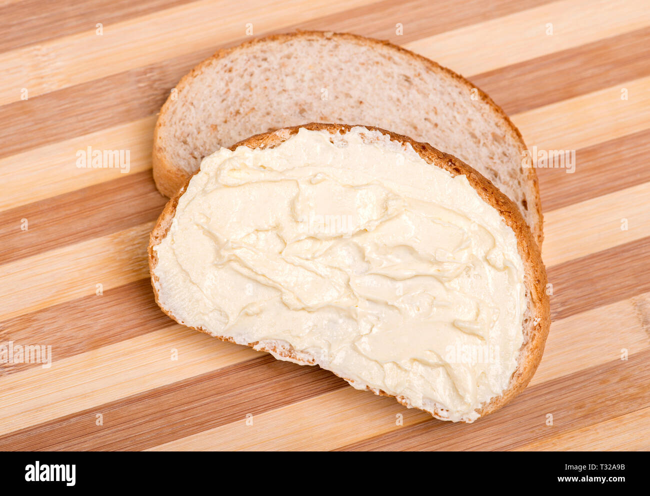 Slices of bread spread with butter Stock Photo - Alamy