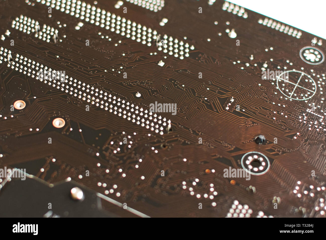 Modern computer ATX format motherboard. Soldering points and conductive ...