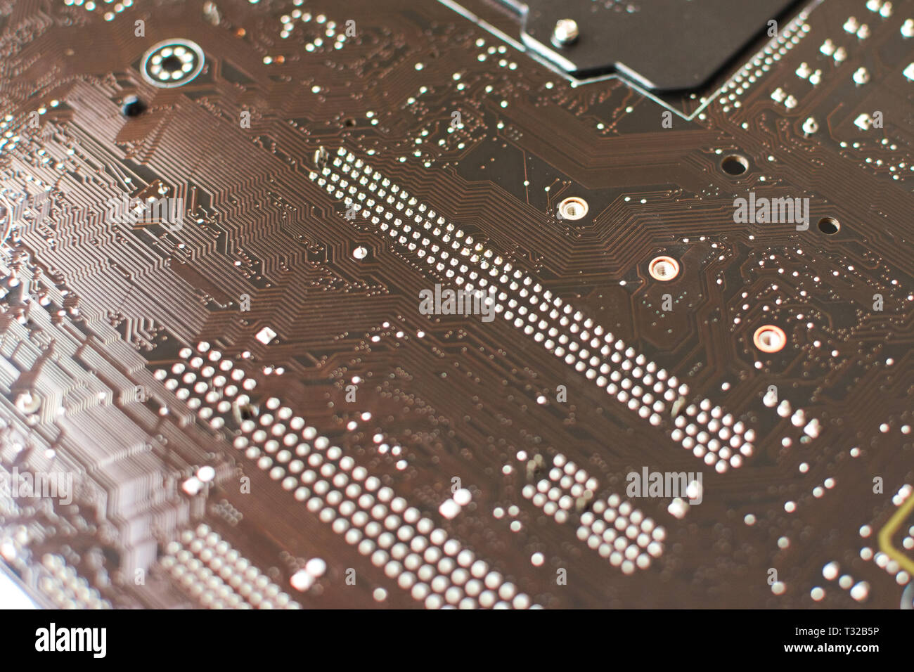 Modern computer ATX format motherboard. Soldering points and conductive ...