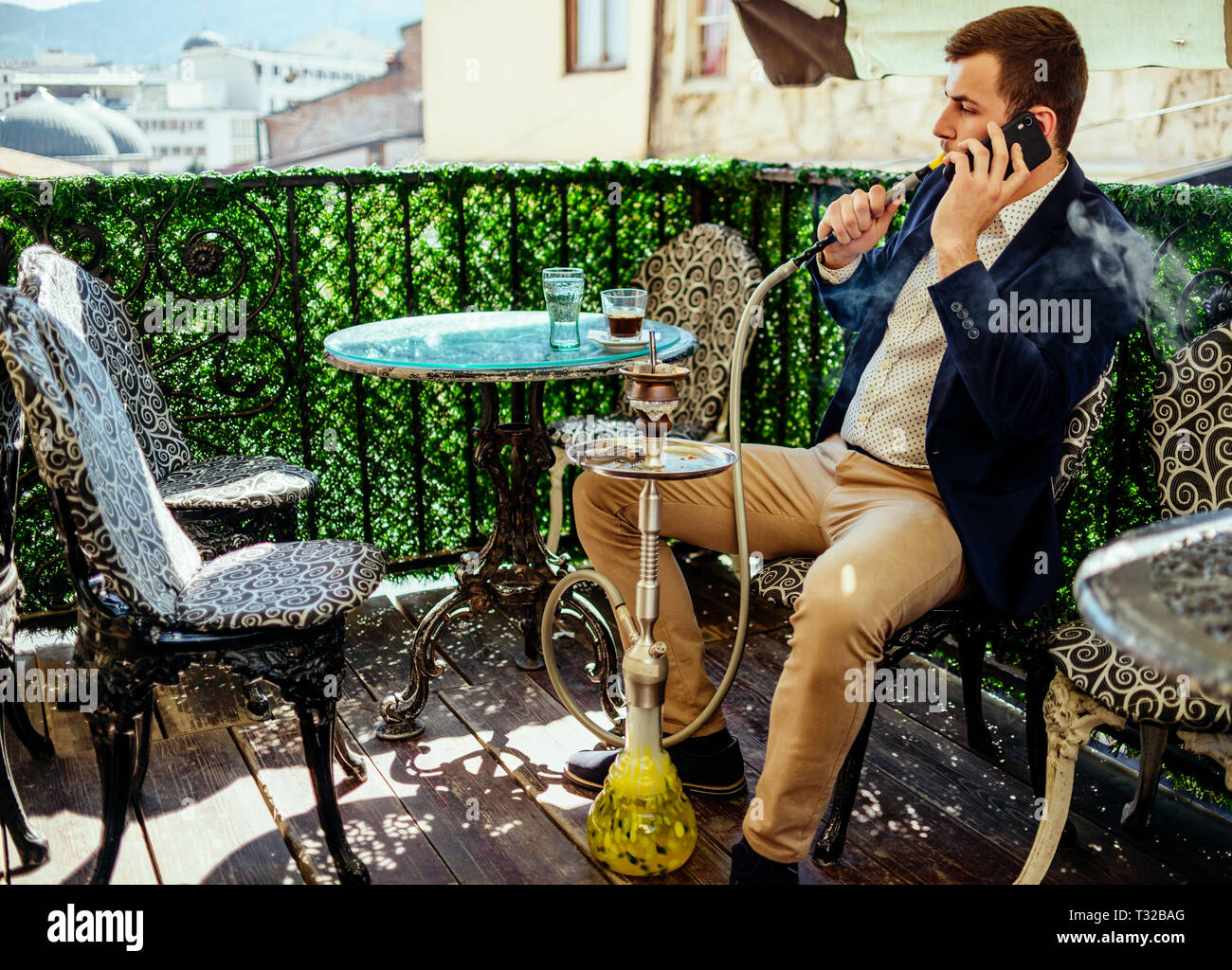 Guy relaxing in balcony hi-res stock photography and images - Alamy