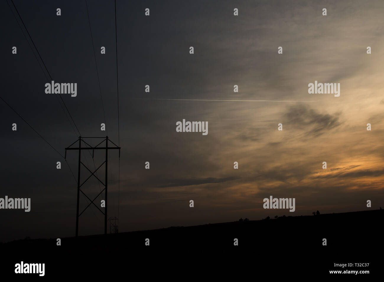 High voltage power line tower silhouetted by a sunset, Polk County ...