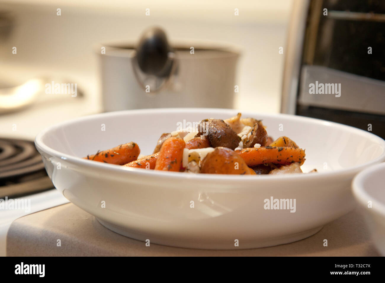 Chicken stew with pot in background Stock Photo - Alamy