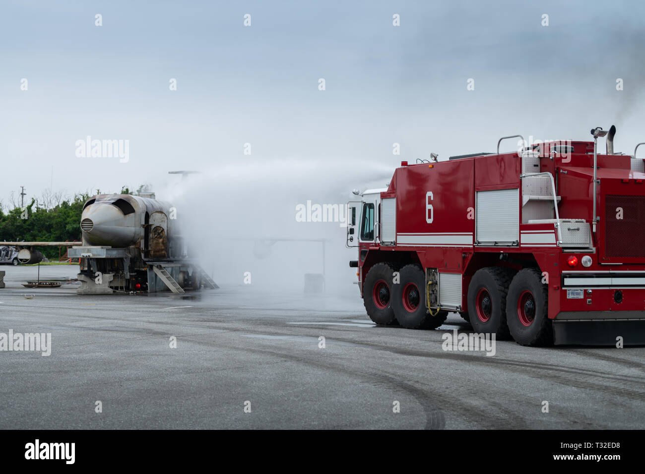 A P-23 aircraft rescue and firefighting crash truck sprays water on a ...