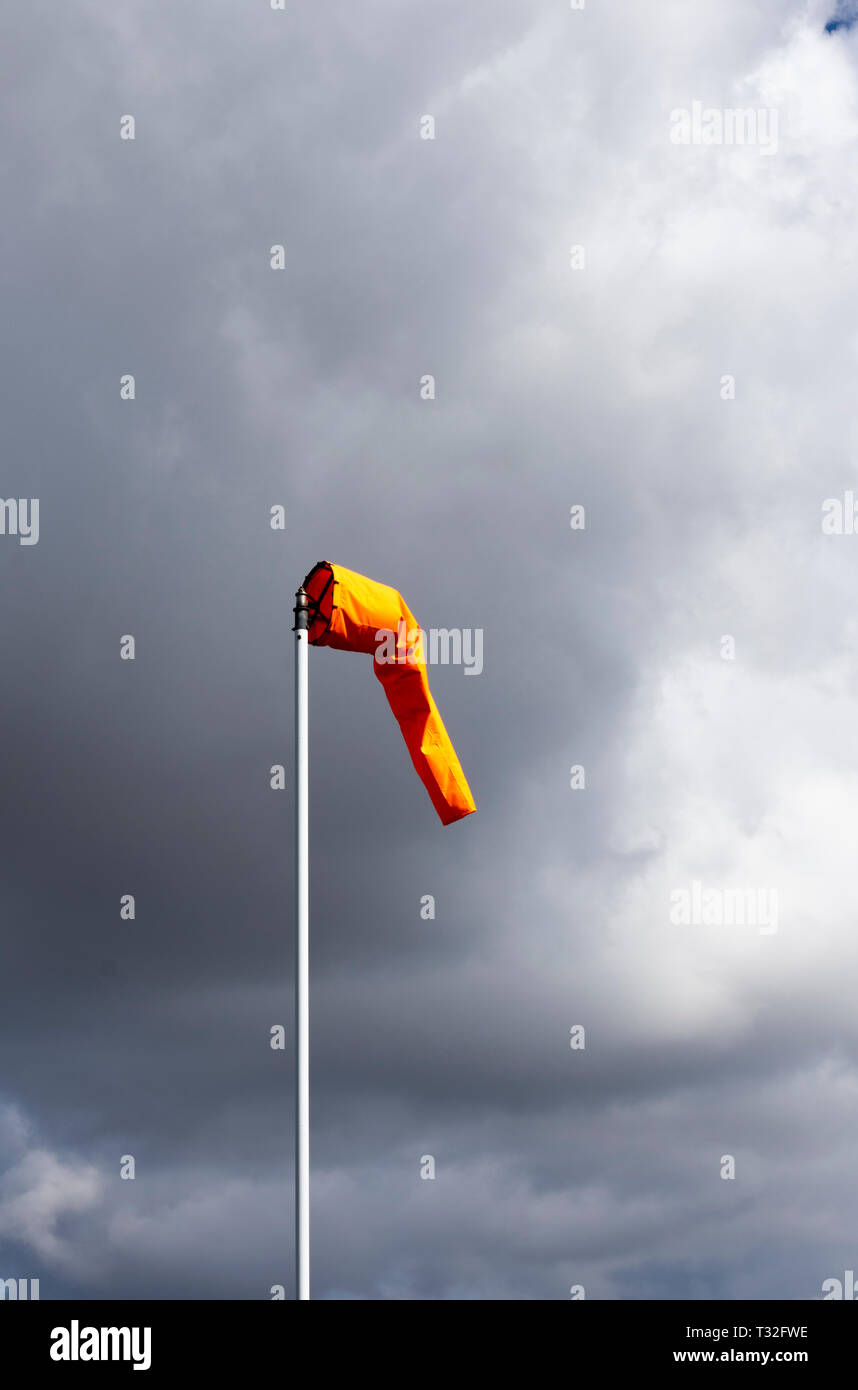 Airfield windsock, used to indicate wind speed and direction, shown ...