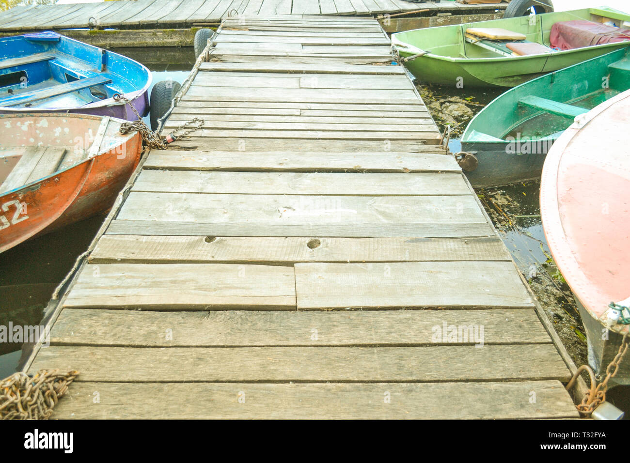 Wooden old dock And the noses of boats Stock Photo - Alamy