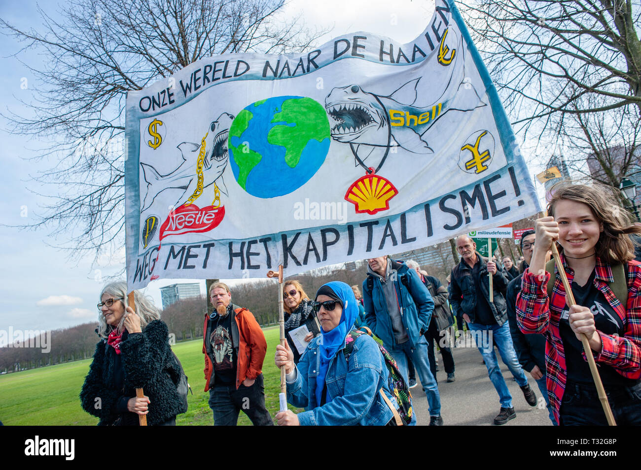 Protesters are seen holding a banner during the anti-Shell ...