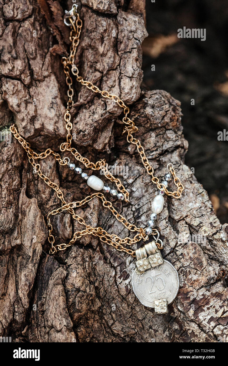 Handmade pendant from original coin on golden chain Stock Photo - Alamy