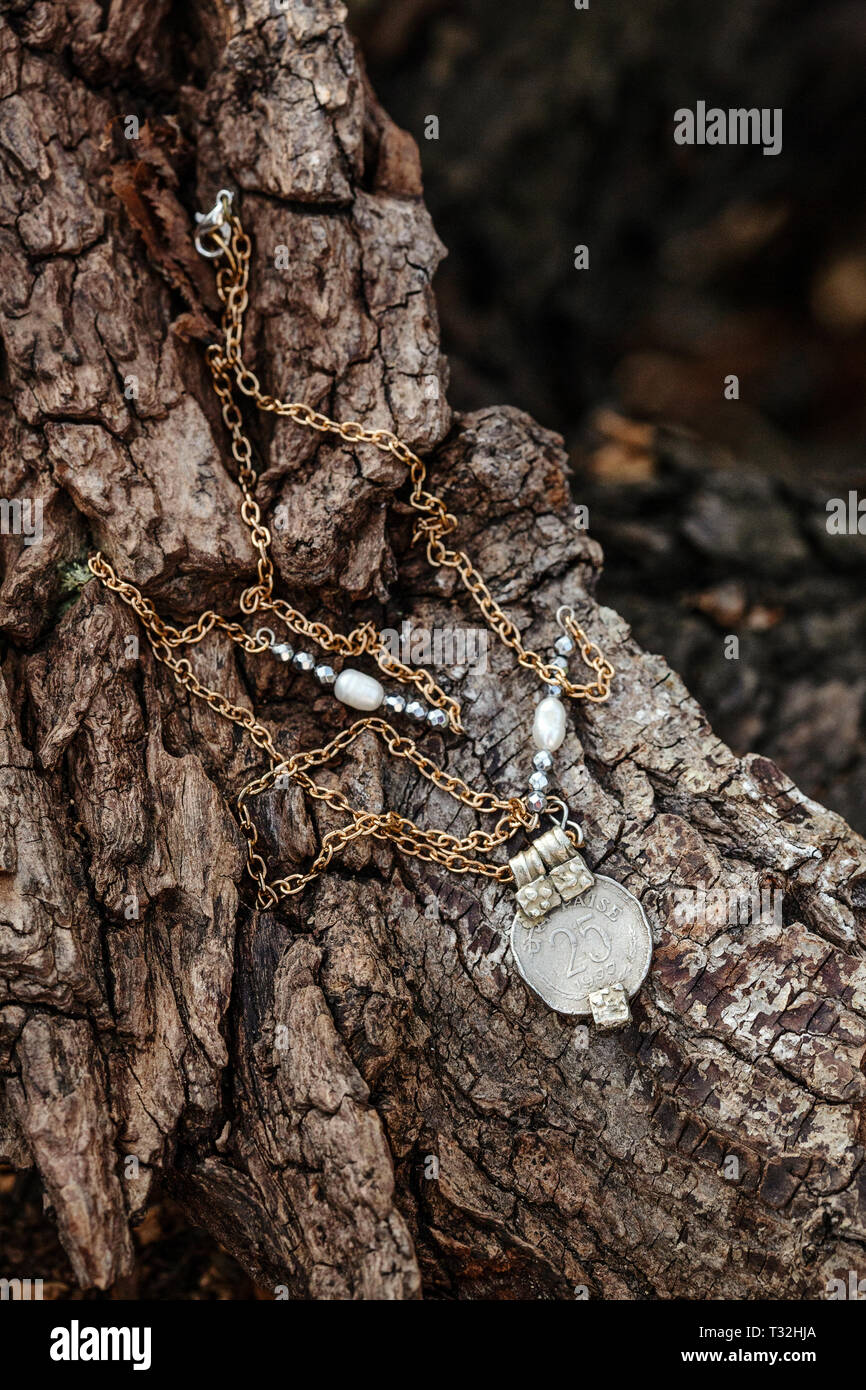Handmade pendant from original coin on golden chain Stock Photo - Alamy