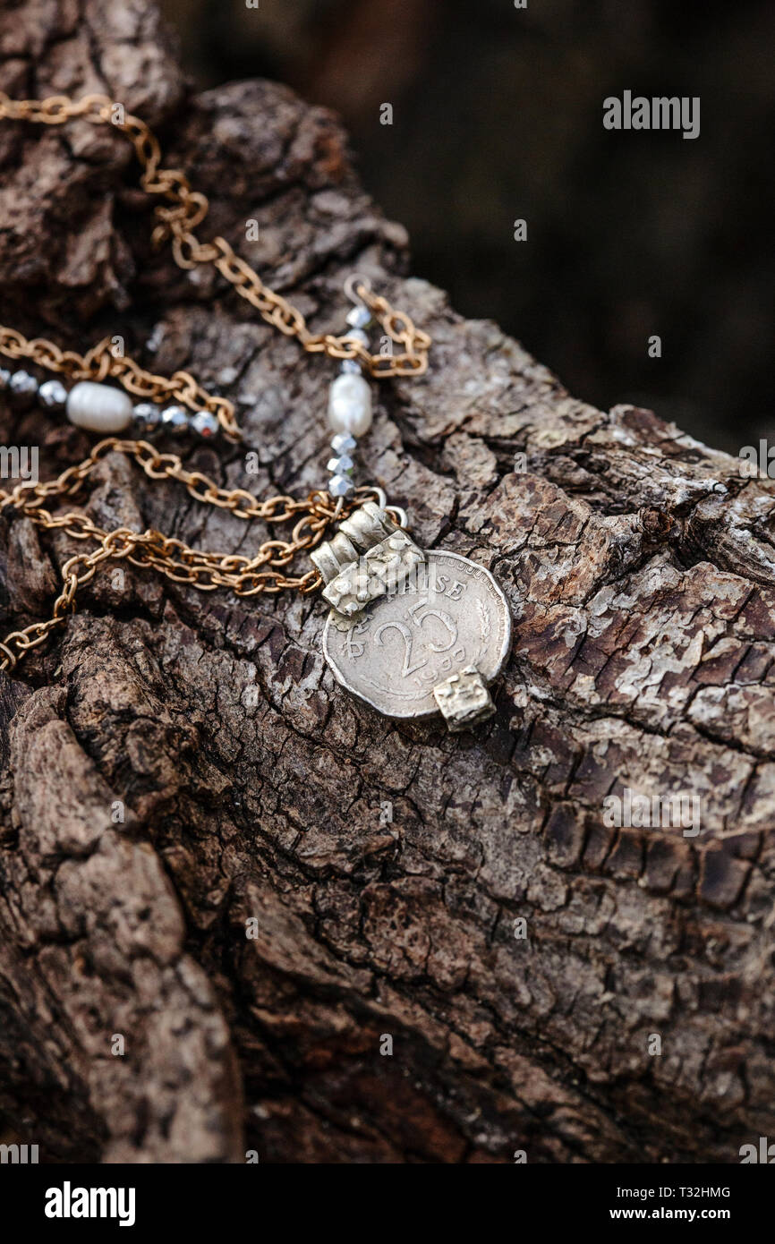 Handmade pendant from original coin on golden chain Stock Photo - Alamy