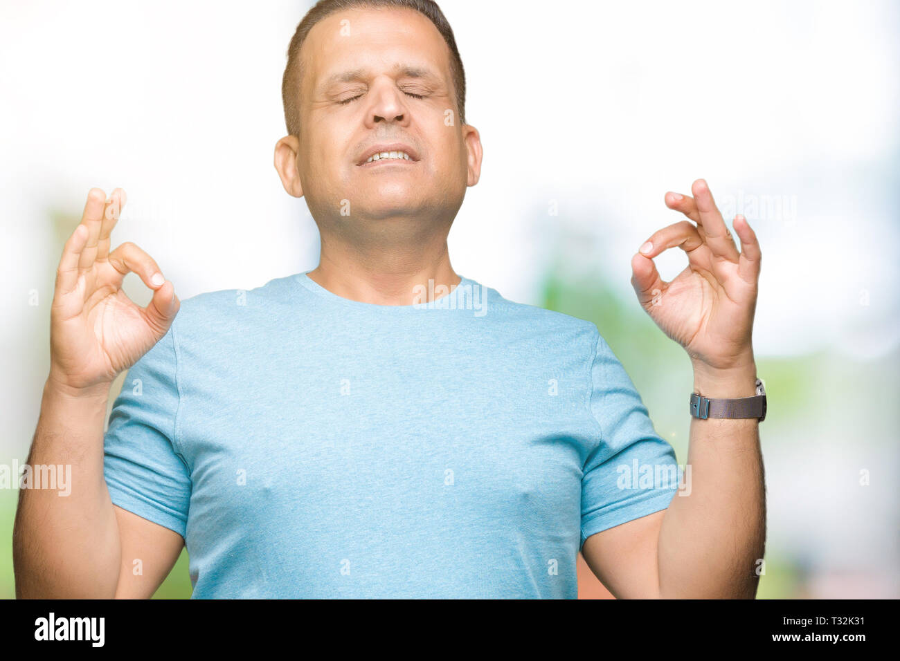 Middle age arab man wearing blue t-shirt over isolated background relax ...