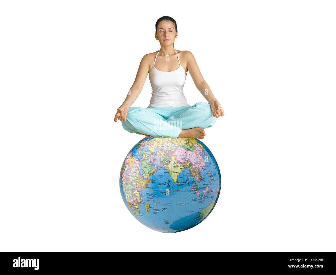WOMAN MEDITATING ON TOP OF GLOBE OF THE EARTH, COMPOSITE IMAGE Stock ...