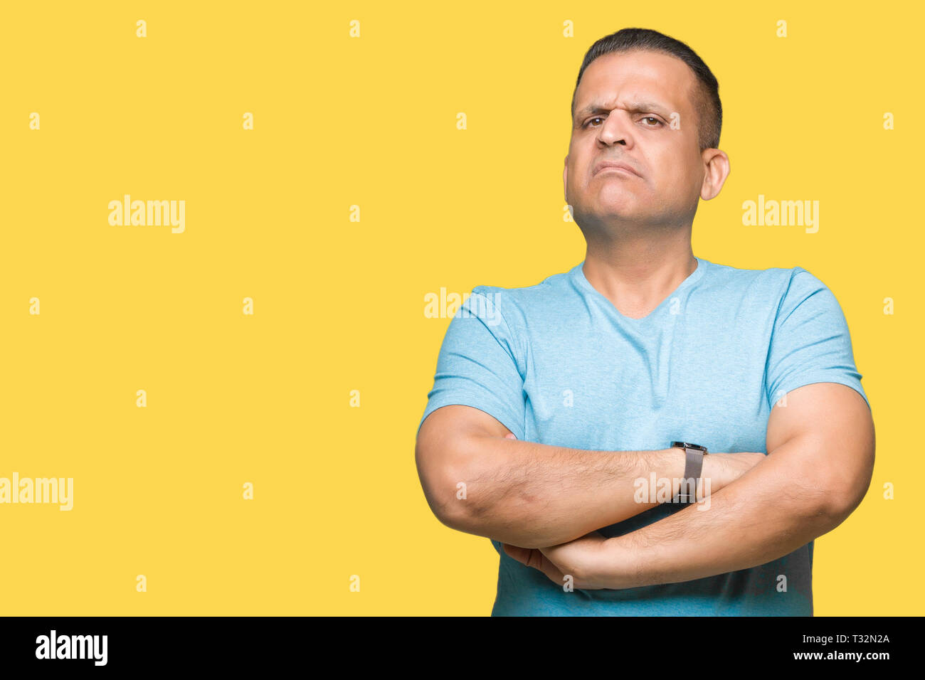Middle age arab man wearing blue t-shirt over isolated background ...