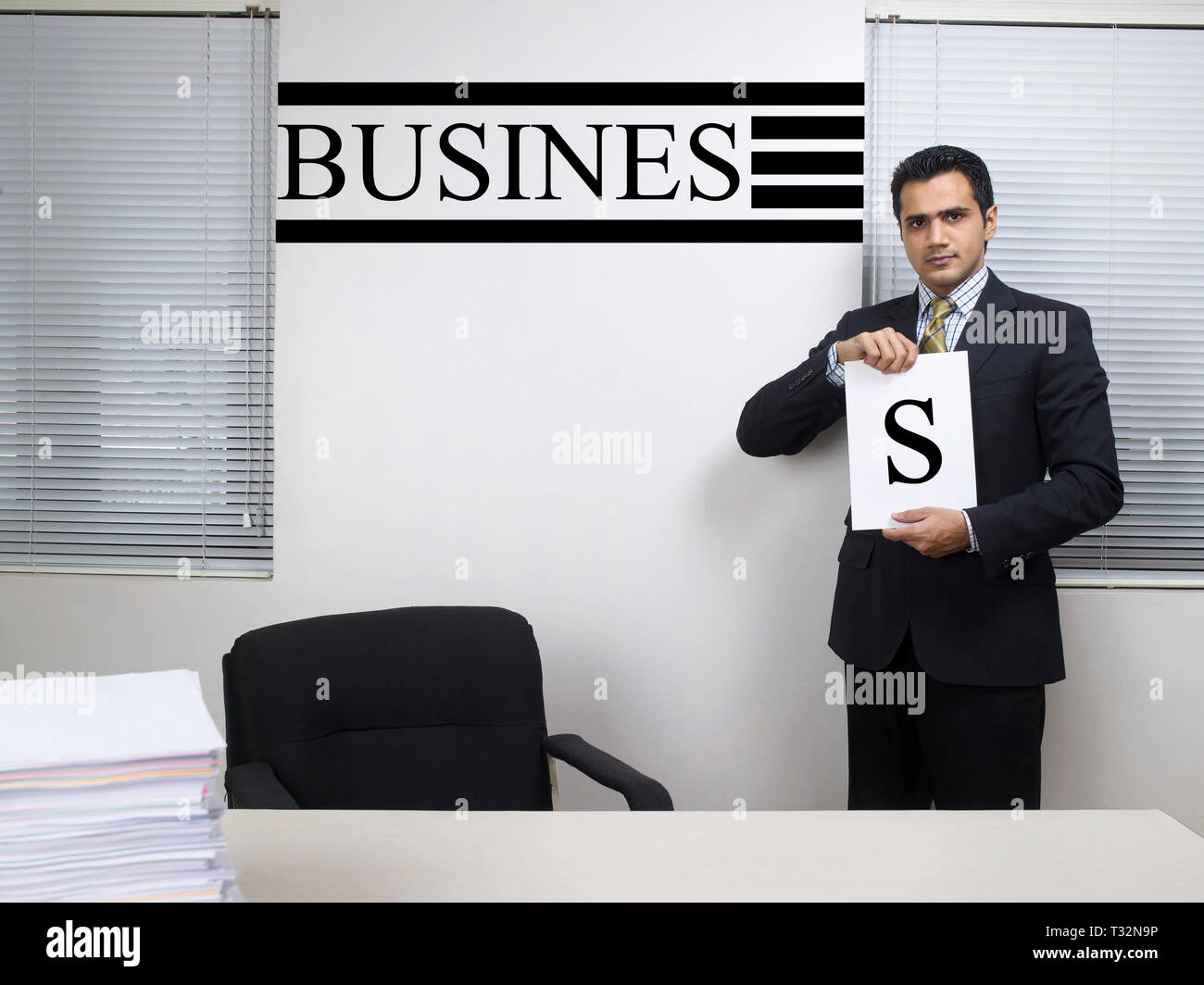 CORPORATE EXECUTIVE HOLDING THE LETTER S , FROM THE WORD BUSINESS IN ...
