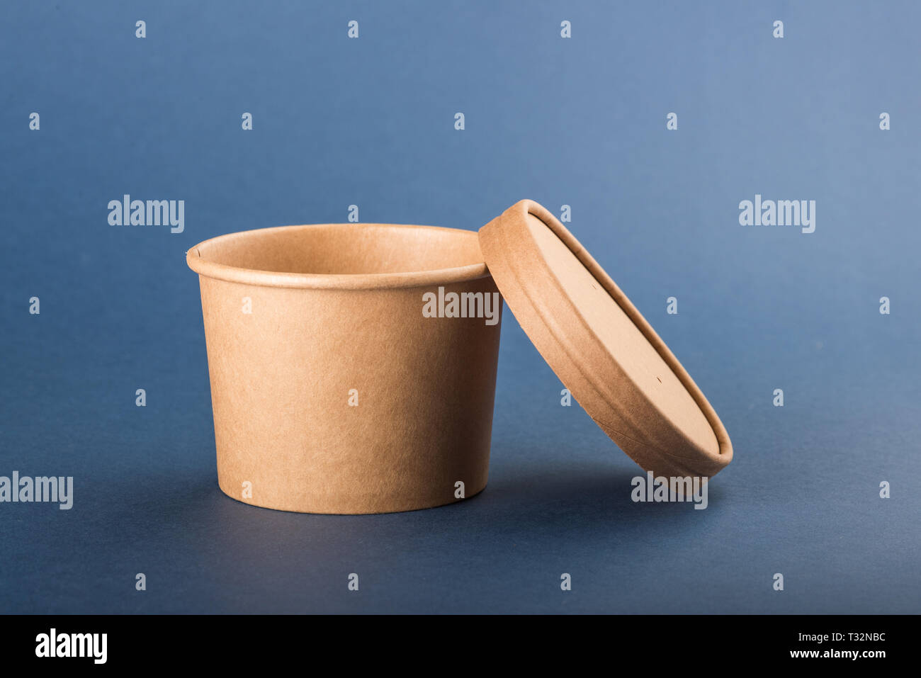 Disposable paper container with cap for soup on a blue background Stock ...