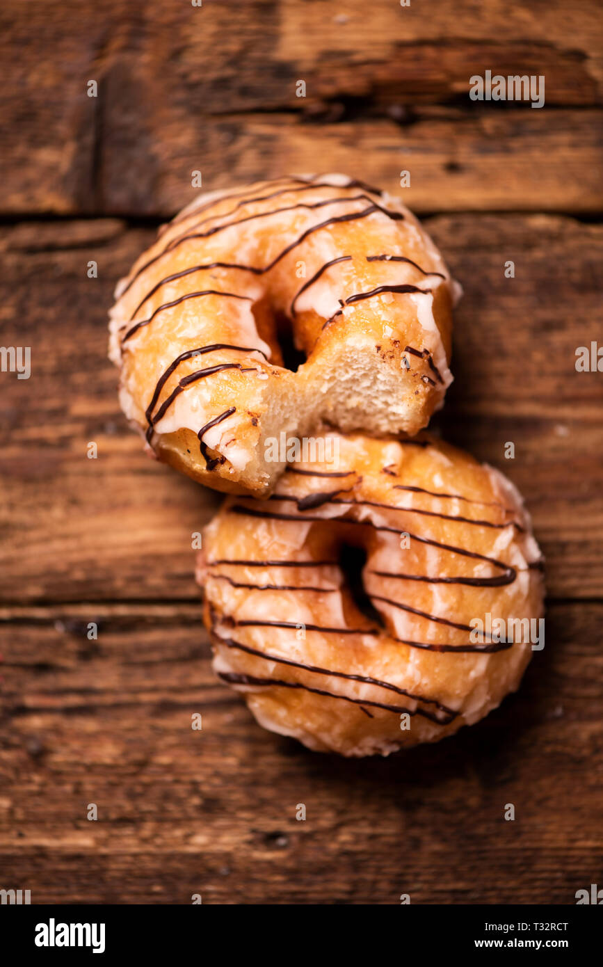 Fresh donuts on nature wooden background Stock Photo - Alamy