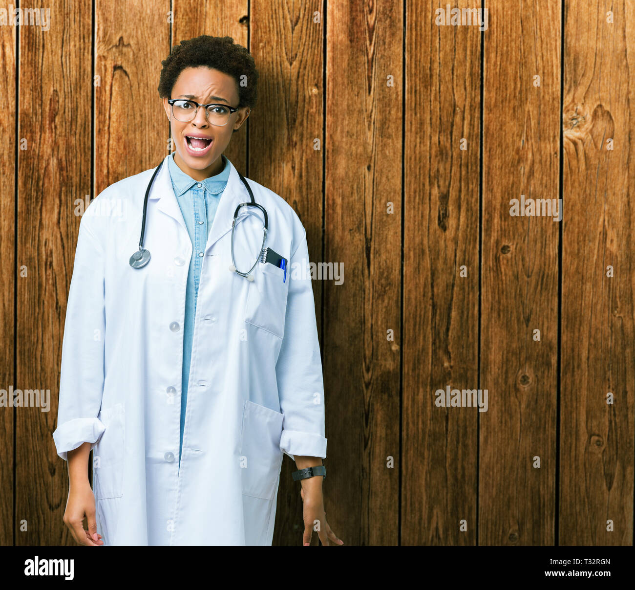 Young african american doctor woman wearing medical coat over isolated ...