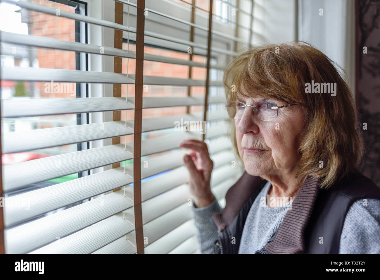 Woman Looking Through Blinds Stock Photos & Woman Looking Through ...