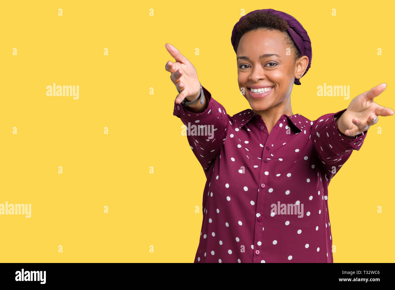 Beautiful young african american woman wearing head scarf over isolated ...