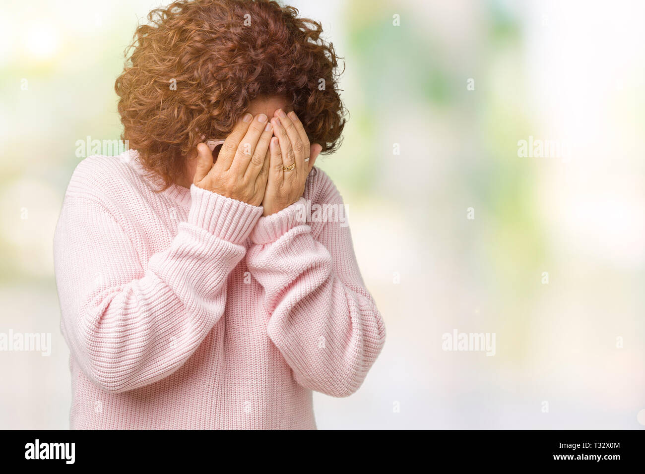 Beautiful middle ager senior woman wearing pink sweater and sunglasses ...