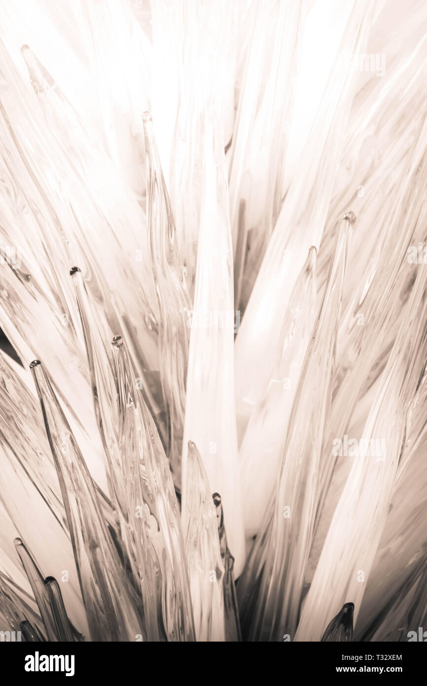 Black and white image of glass spikes that are darker on the bottom and ...