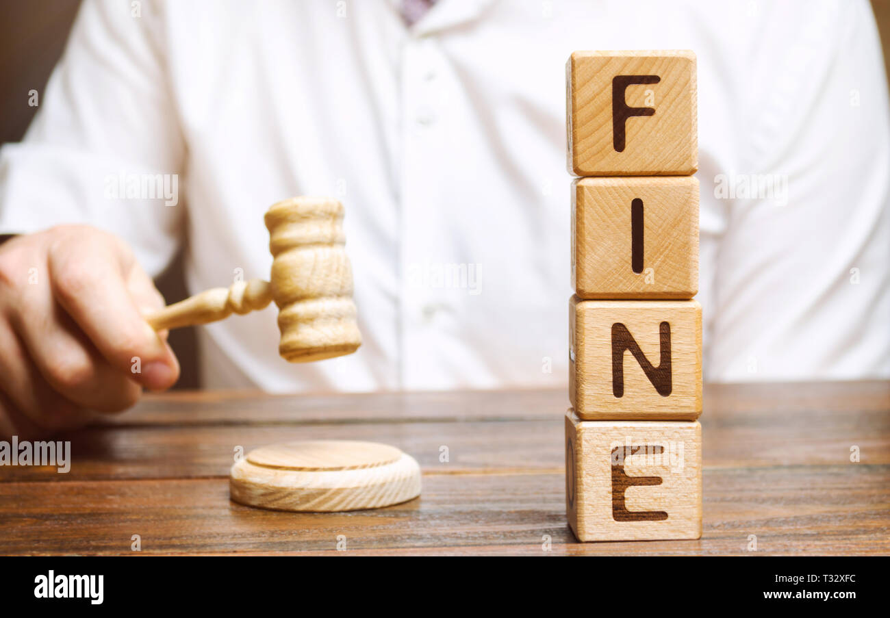 Wooden blocks with the word Fine and judge. Penalty as a punishment for ...