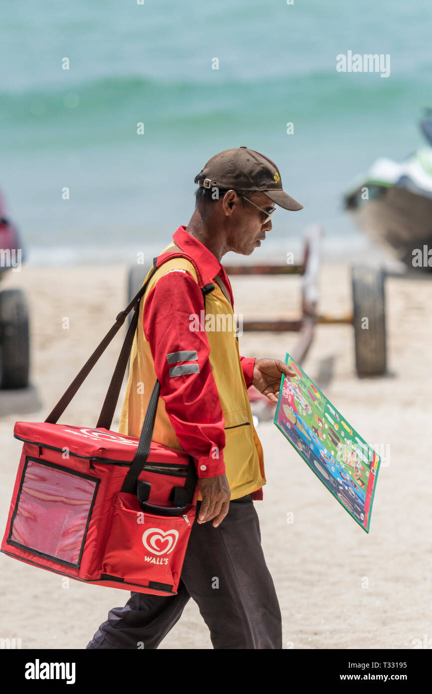 a beach trader or salesman selling gifts and souvenirs on the beach at ...