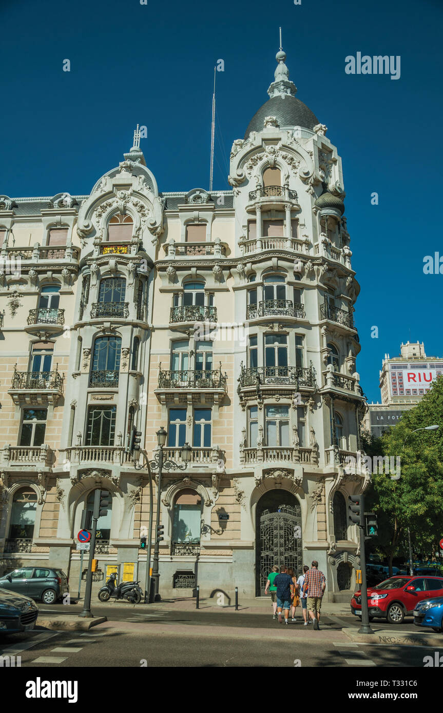 Building with flamboyant facade and people walking on a busy street in ...