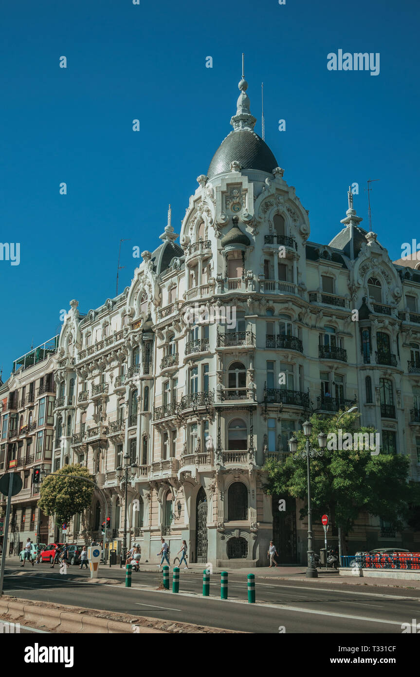 Building with flamboyant facade and people walking on a busy street in ...