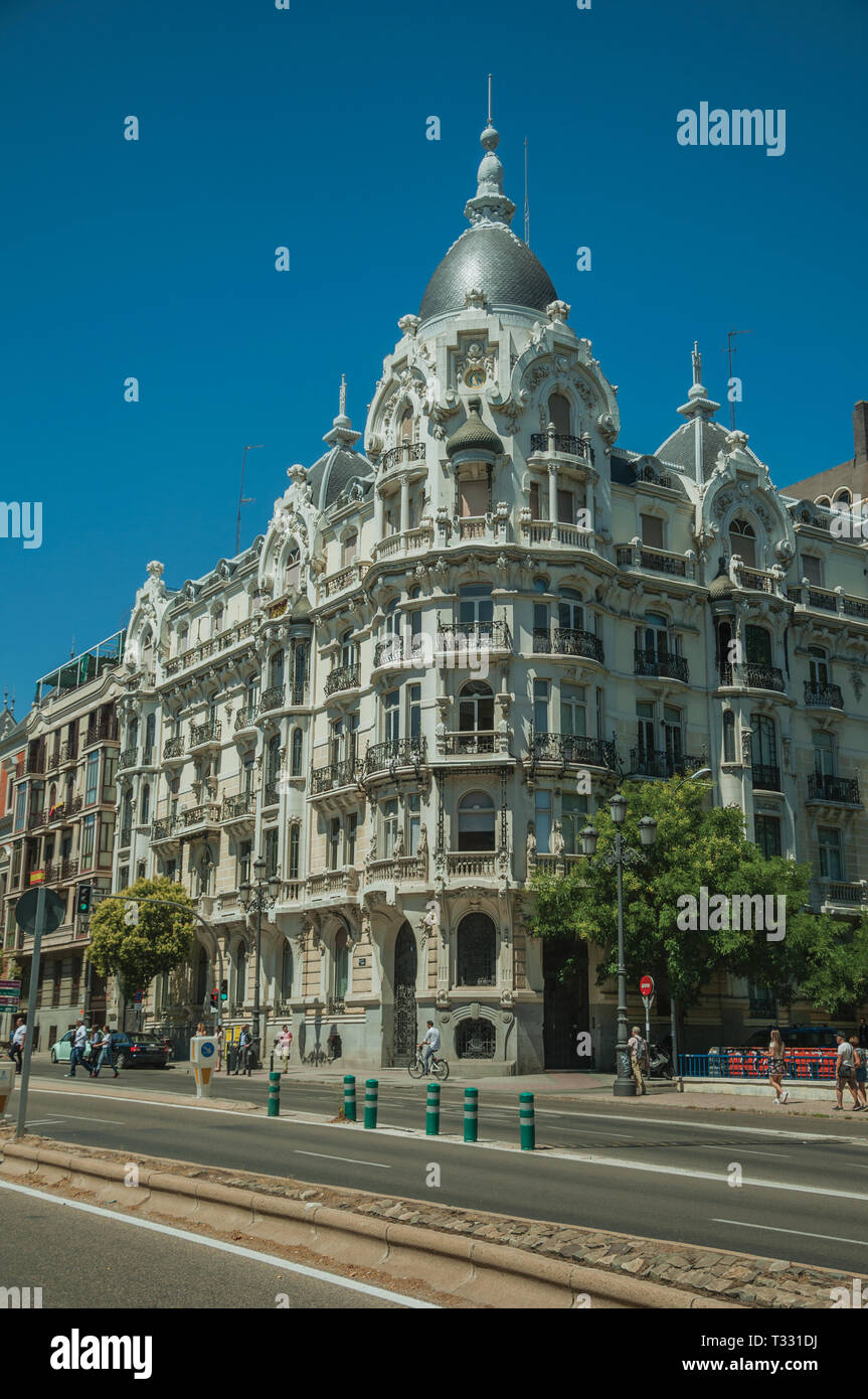 Building with flamboyant facade and people walking on a busy street in ...